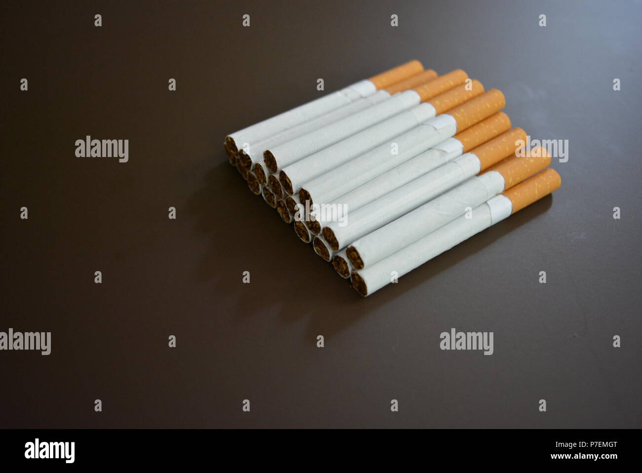New decomposed many cigarettes on a brown matte background Stock Photo ...