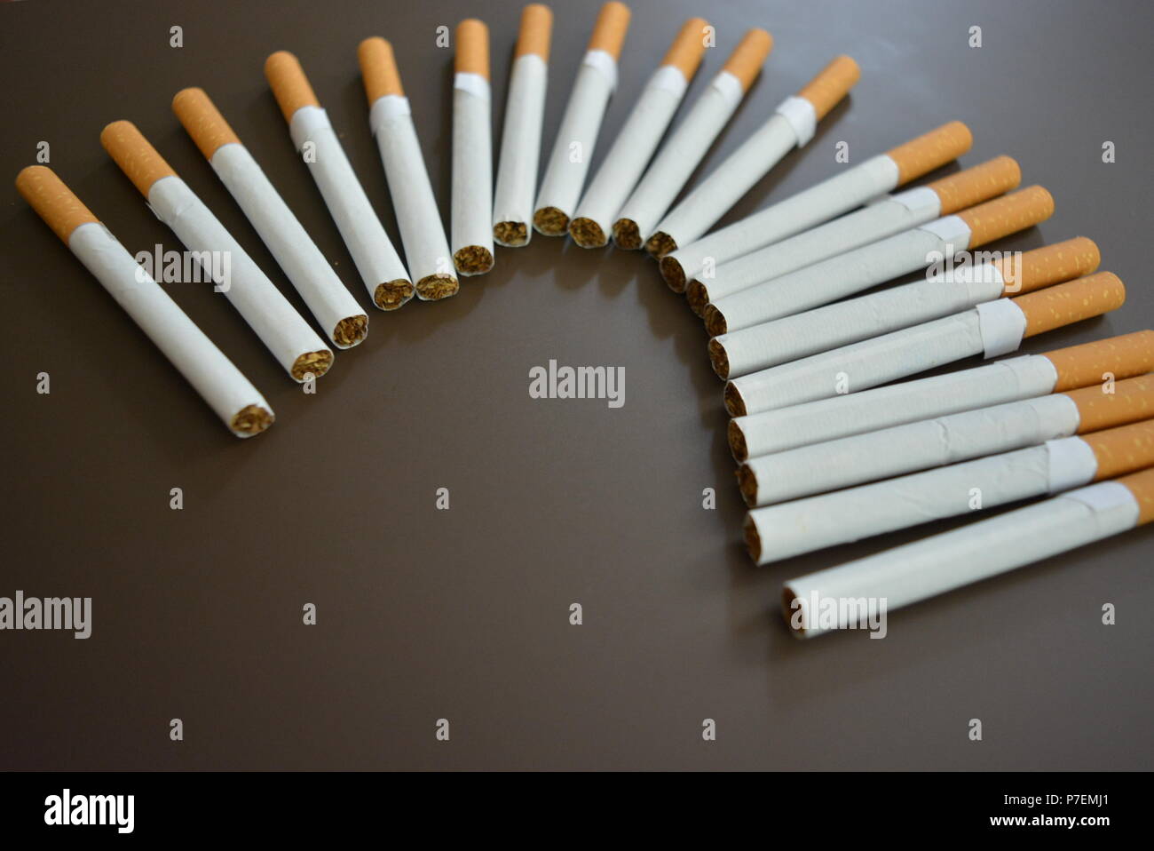 New decomposed many cigarettes on a brown matte background Stock Photo ...