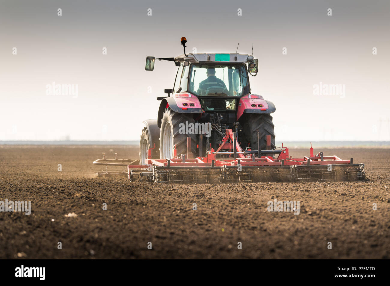 Tractor preparing land for sowings Stock Photo - Alamy