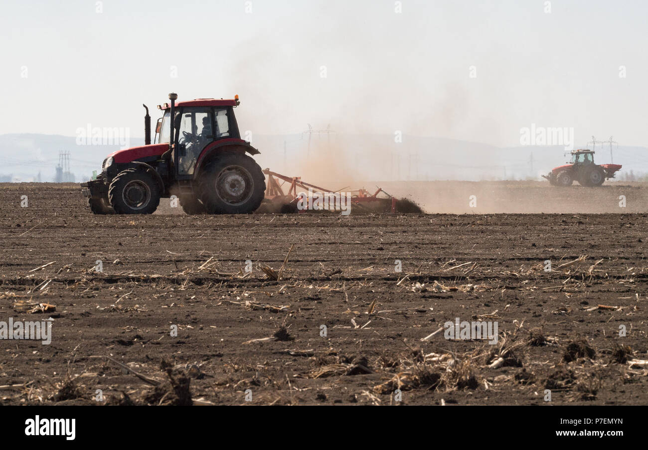 Tractor preparing land for sowing Stock Photo - Alamy