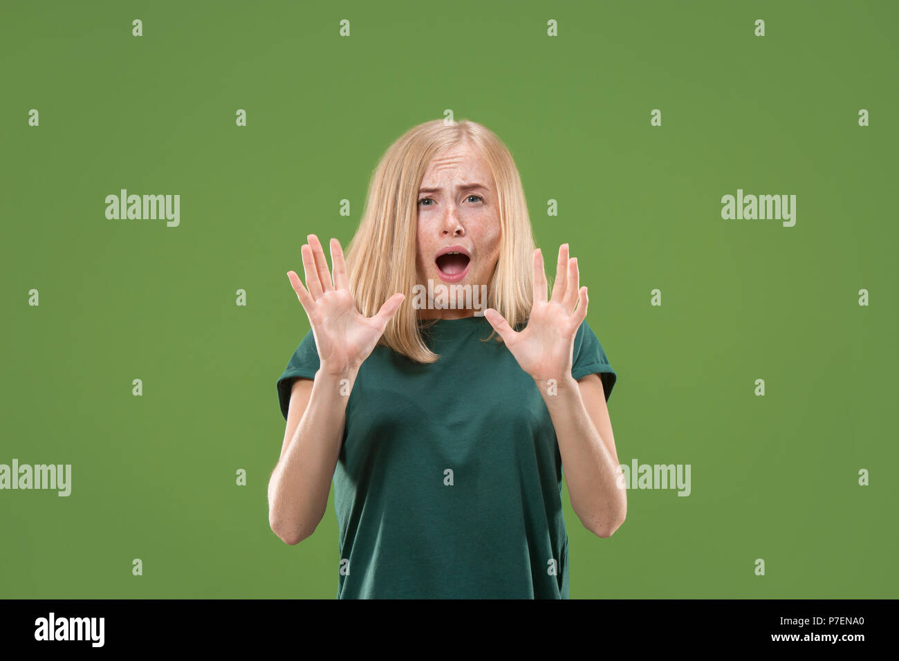 Portrait of the scared woman on green Stock Photo - Alamy