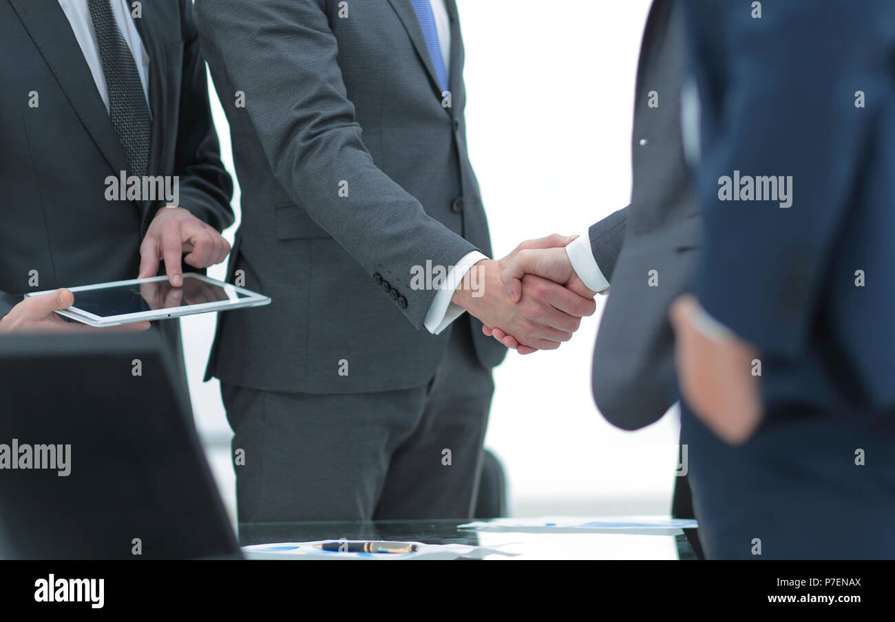 Business partners handshaking with their colleagues Stock Photo - Alamy