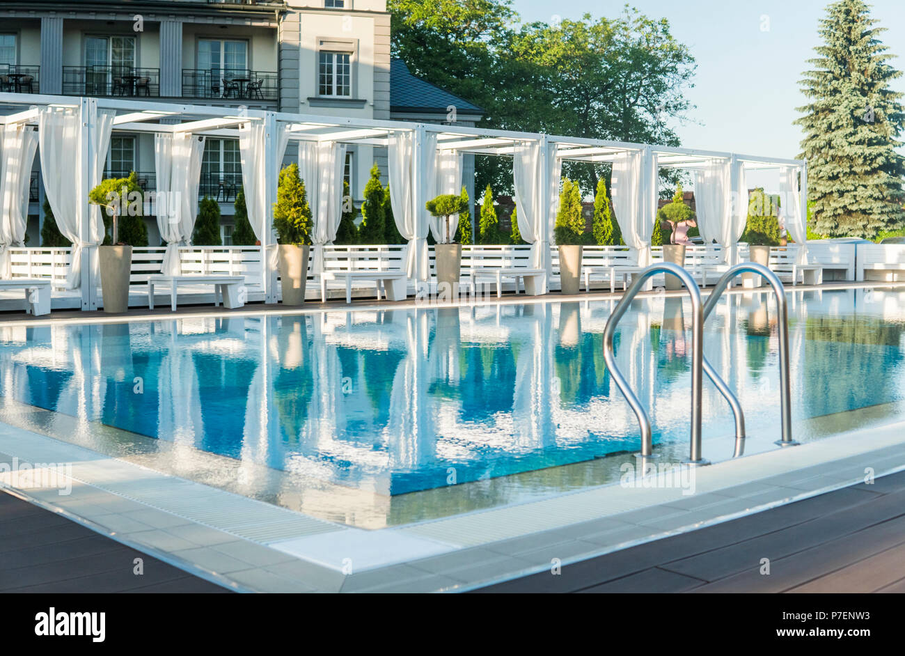 Outdoor sunny swimming pool of luxury hotel and resort with a ...