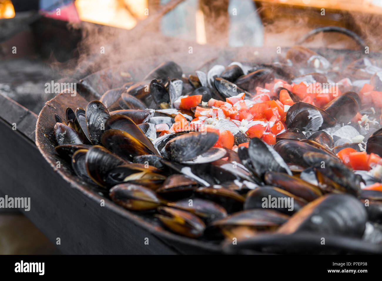 Fresh mussels at grill pan. Seafood barbecue outdoors. Picnic healthy ...