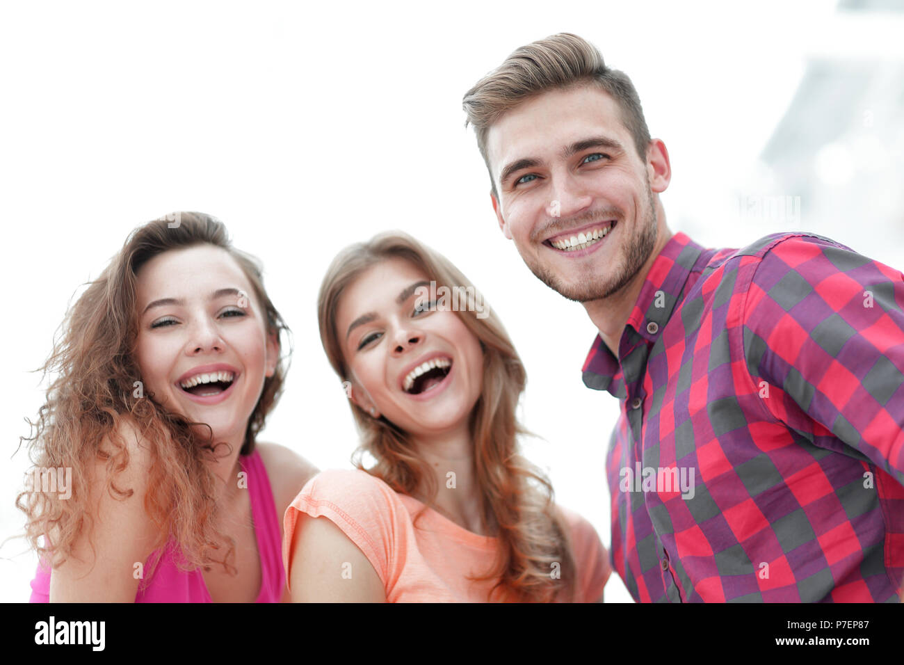closeup of three young people smiling on white background Stock Photo ...