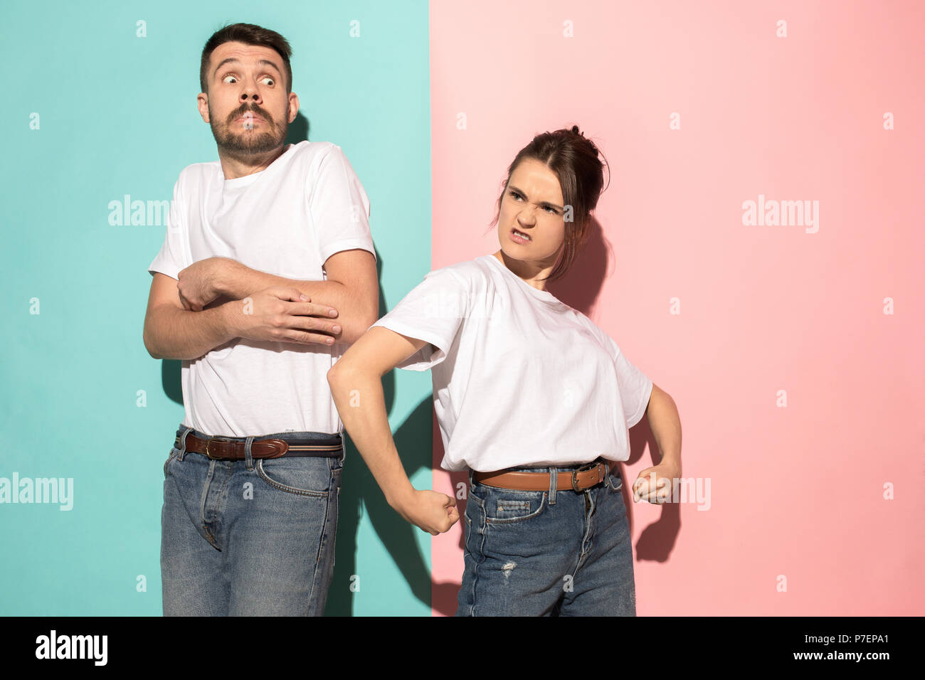 The young emotional angry woman on pink studio background Stock Photo ...