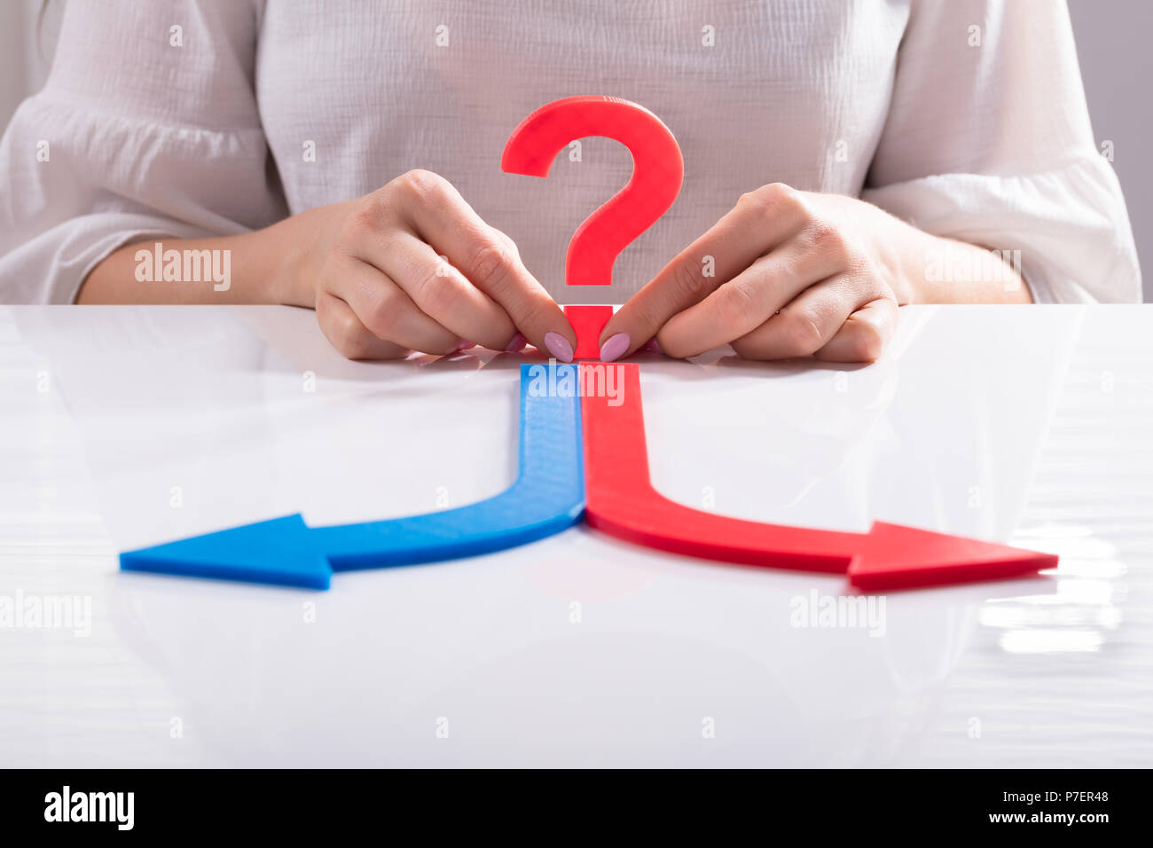 Blue And Red Arrows In Front Of Woman's Hand Showing Directions Stock ...