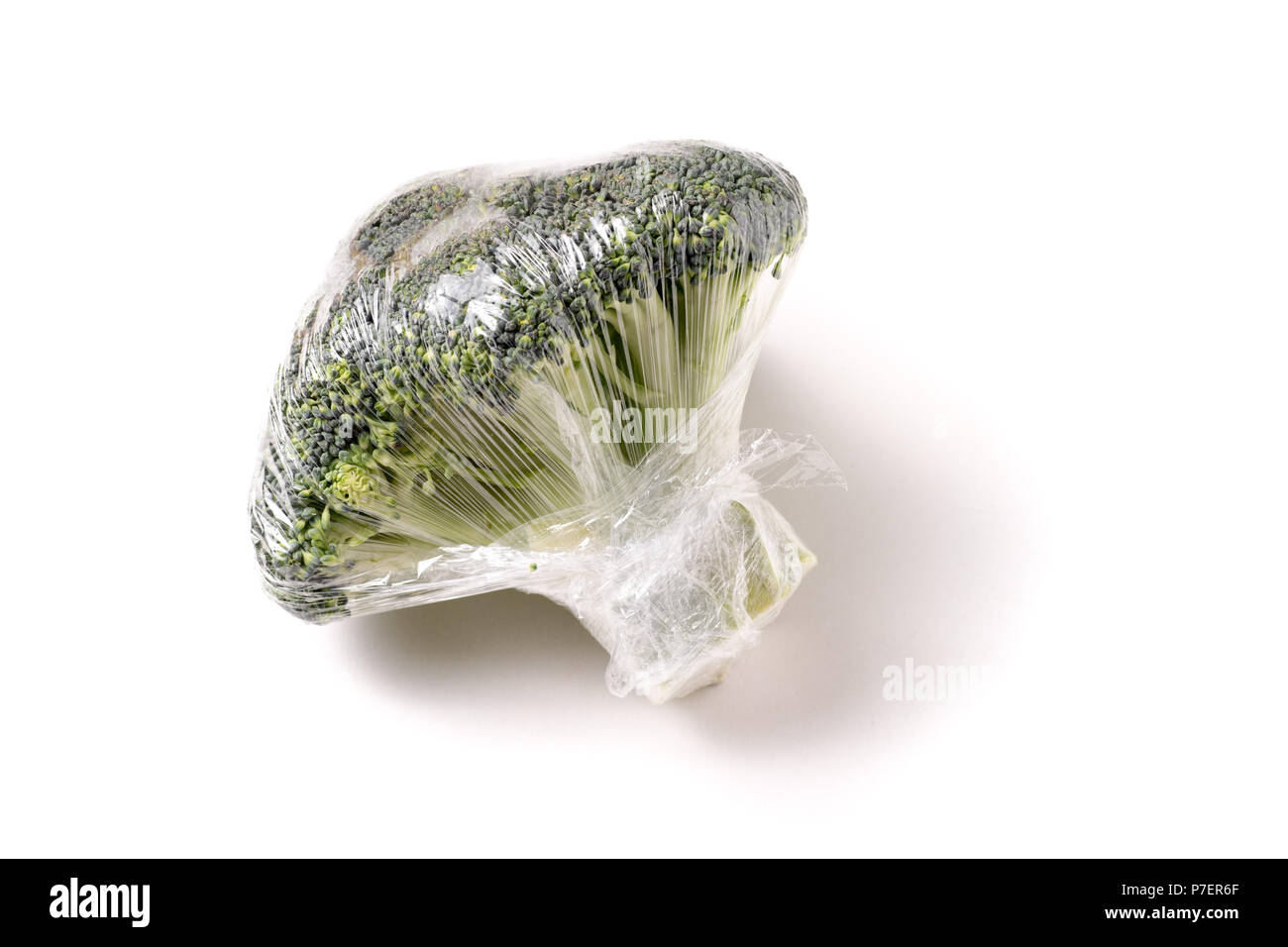 Organic Broccoli wrap in plastic, isolated on white background Stock ...