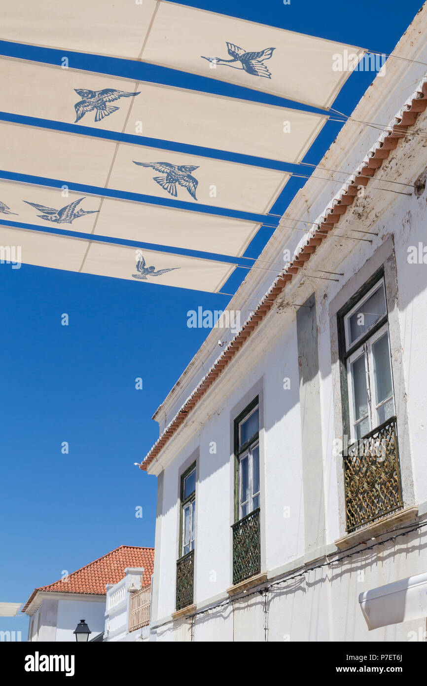 White facade of a traditional portuguese building. Line of the roof ...