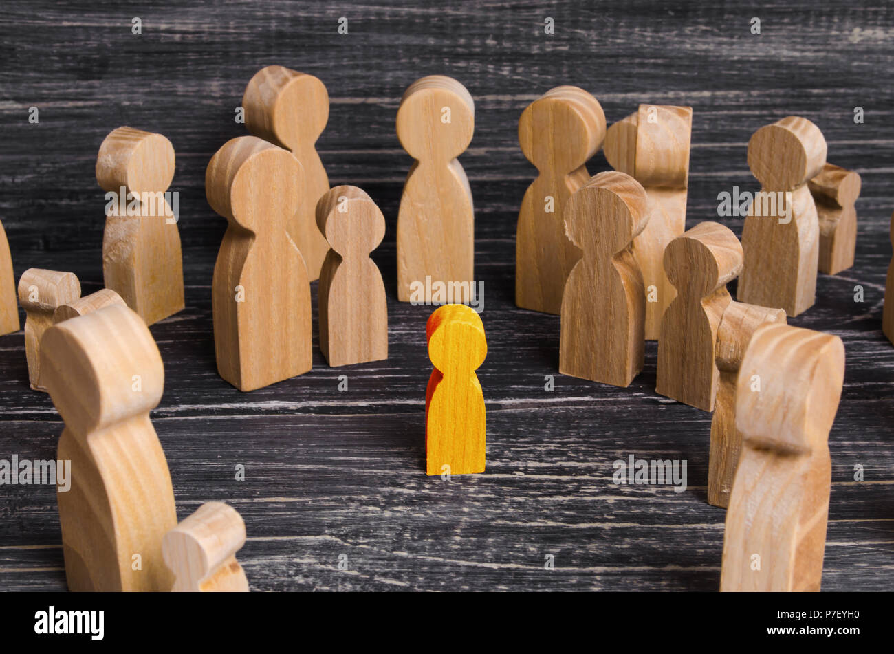 The child was lost in the crowd. A crowd of wooden figures of people ...