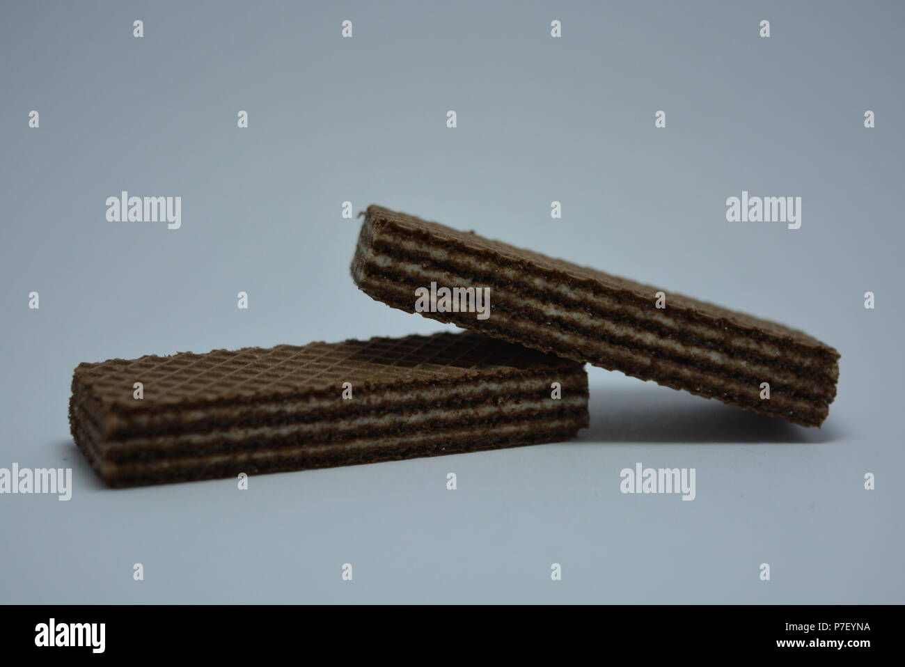 On white paper sweet chocolate wafers with white coconut filling Stock ...