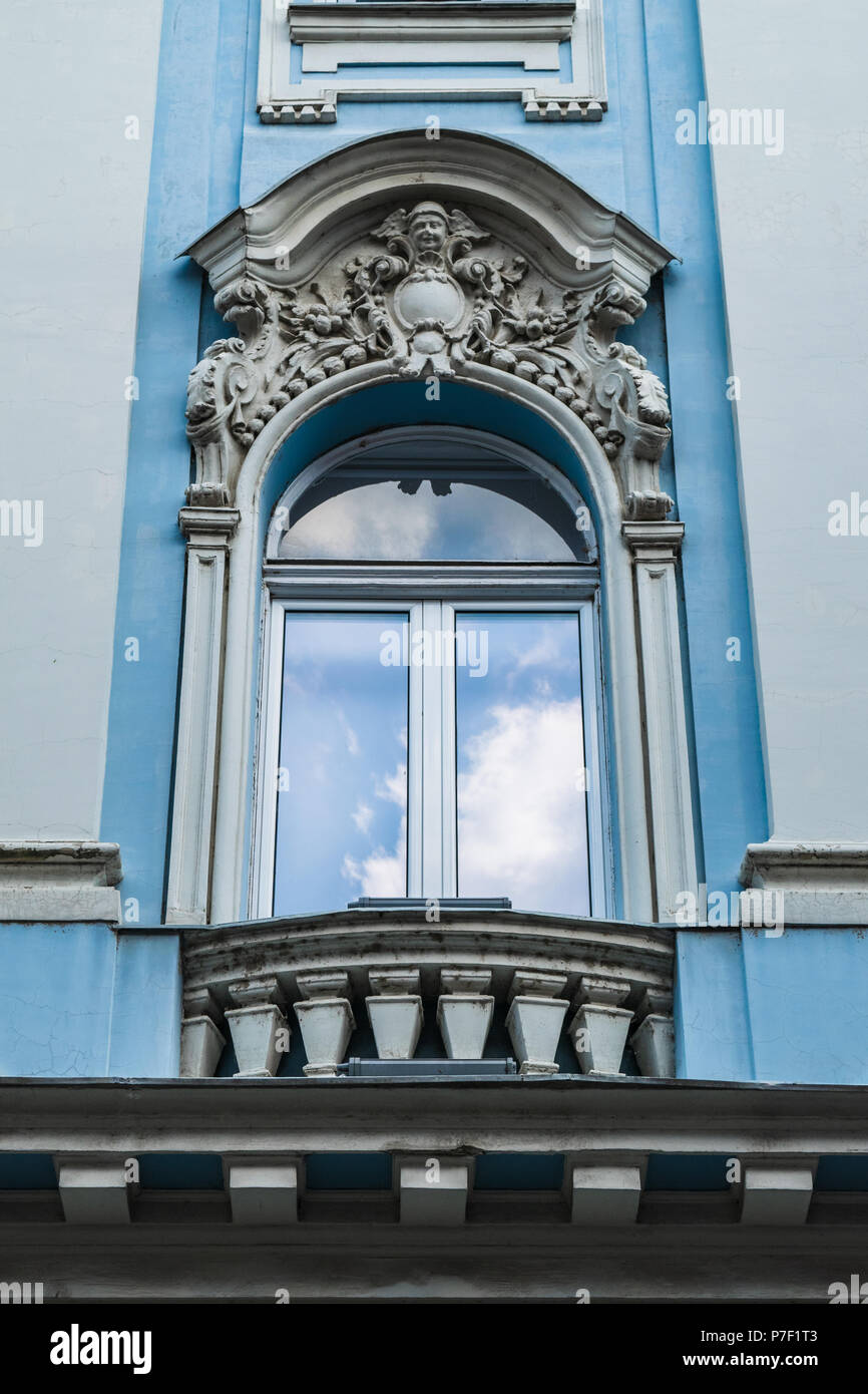A window and balcony with bas-relief on facade. Decorative window ...
