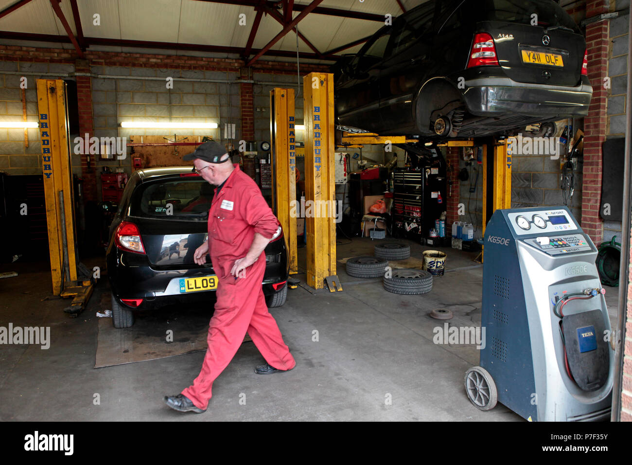 a MOTOR mechanic working on AND FIXING cars in north WEST London, UK ...