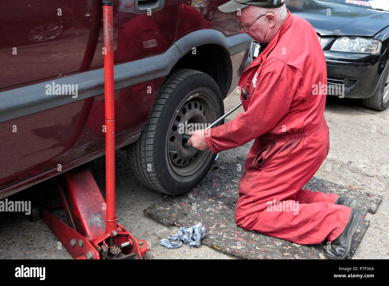 a MOTOR mechanic working on AND FIXING cars in north WEST London, UK ...