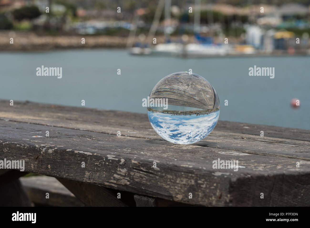 Picnic table holding round sphere lens that shows Ventura Marina ...