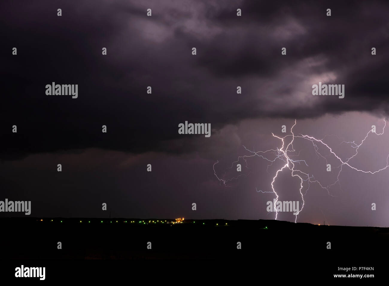 A mezocyclone lightning storm with dark clouds forming over a small ...