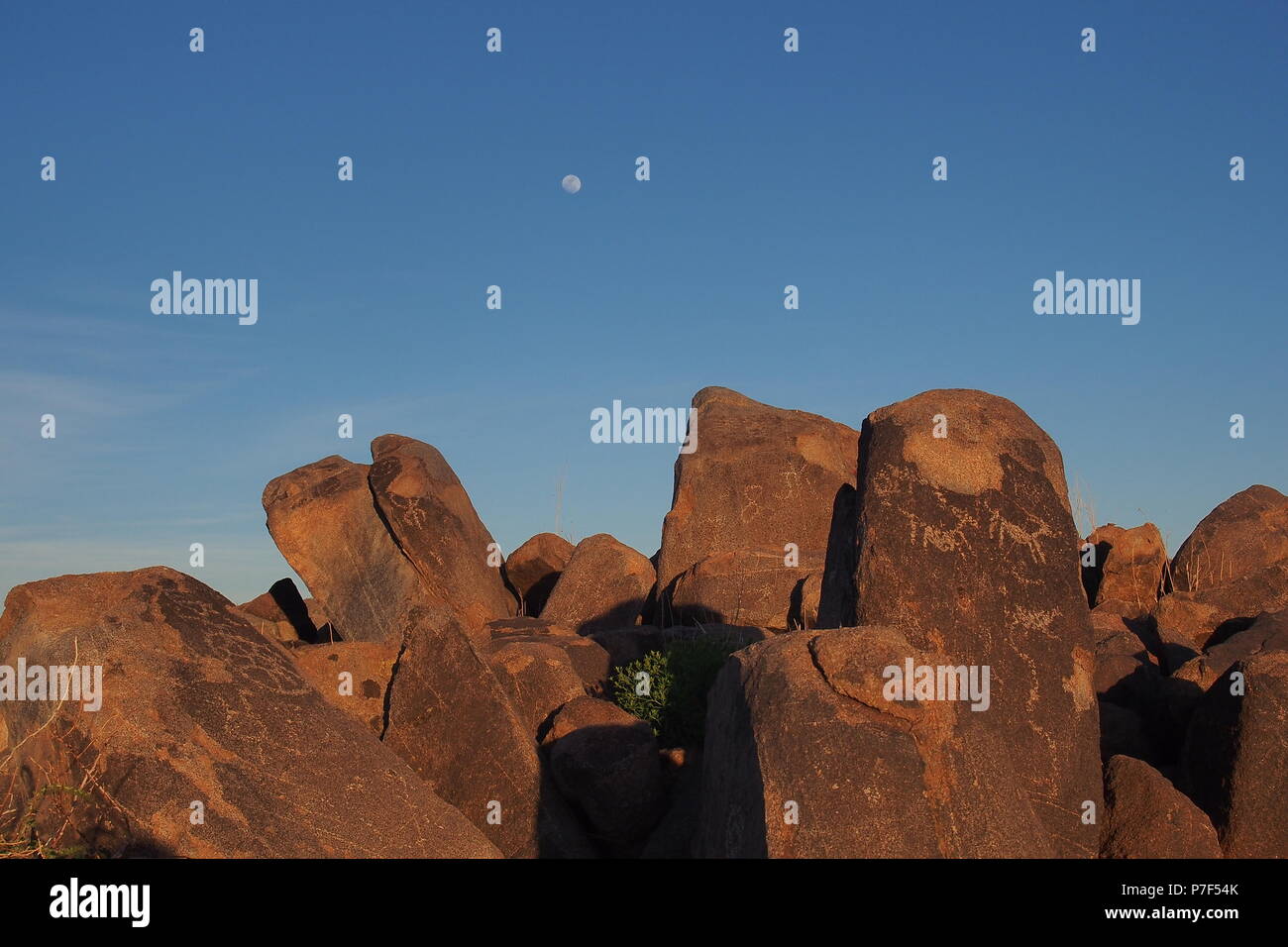 Rising moon behind rocks with Hohokam petroglyphs on Signal Hill in ...