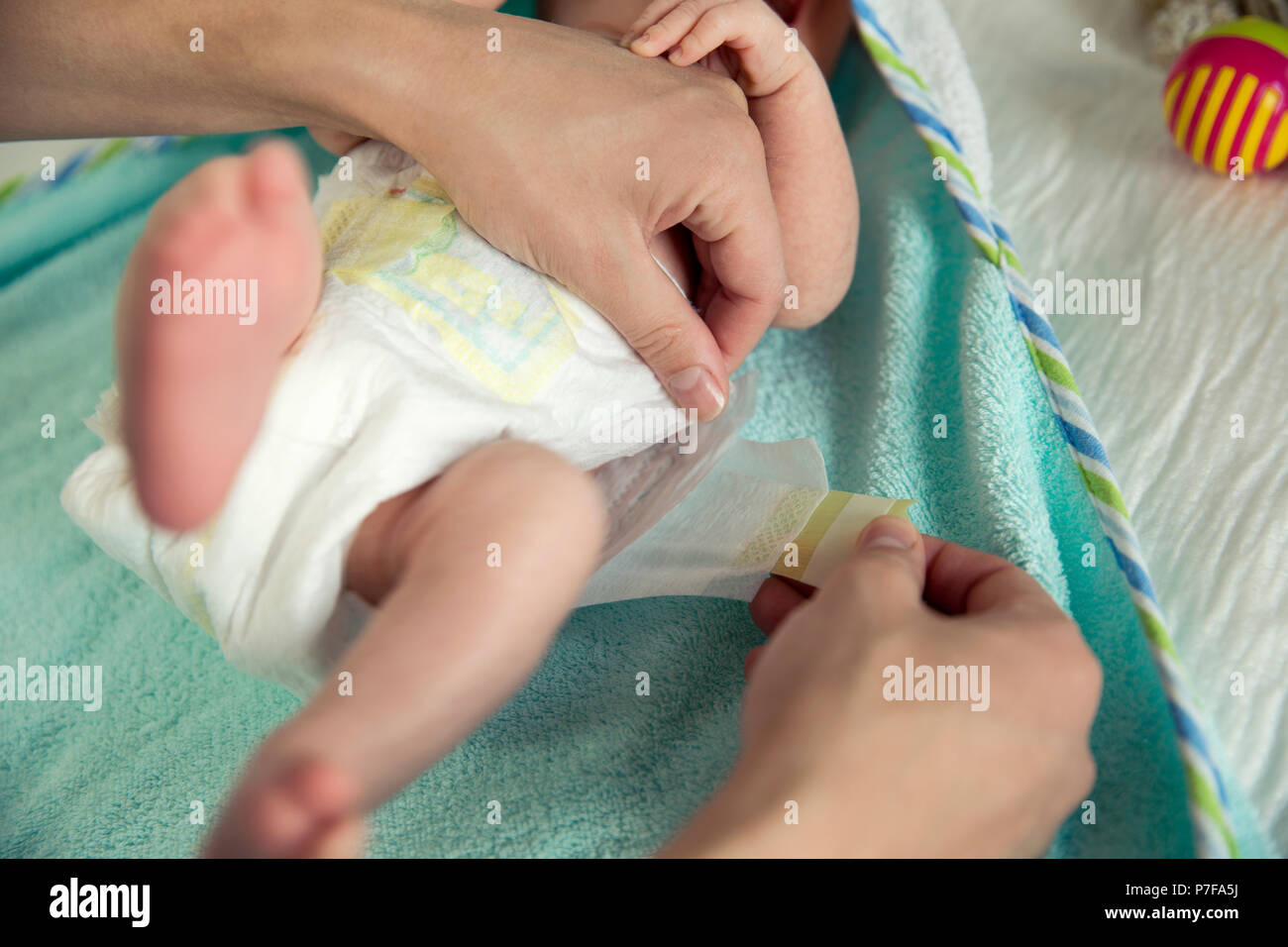 Mother changes diapers to her newborn baby. Motherhood daily routine ...