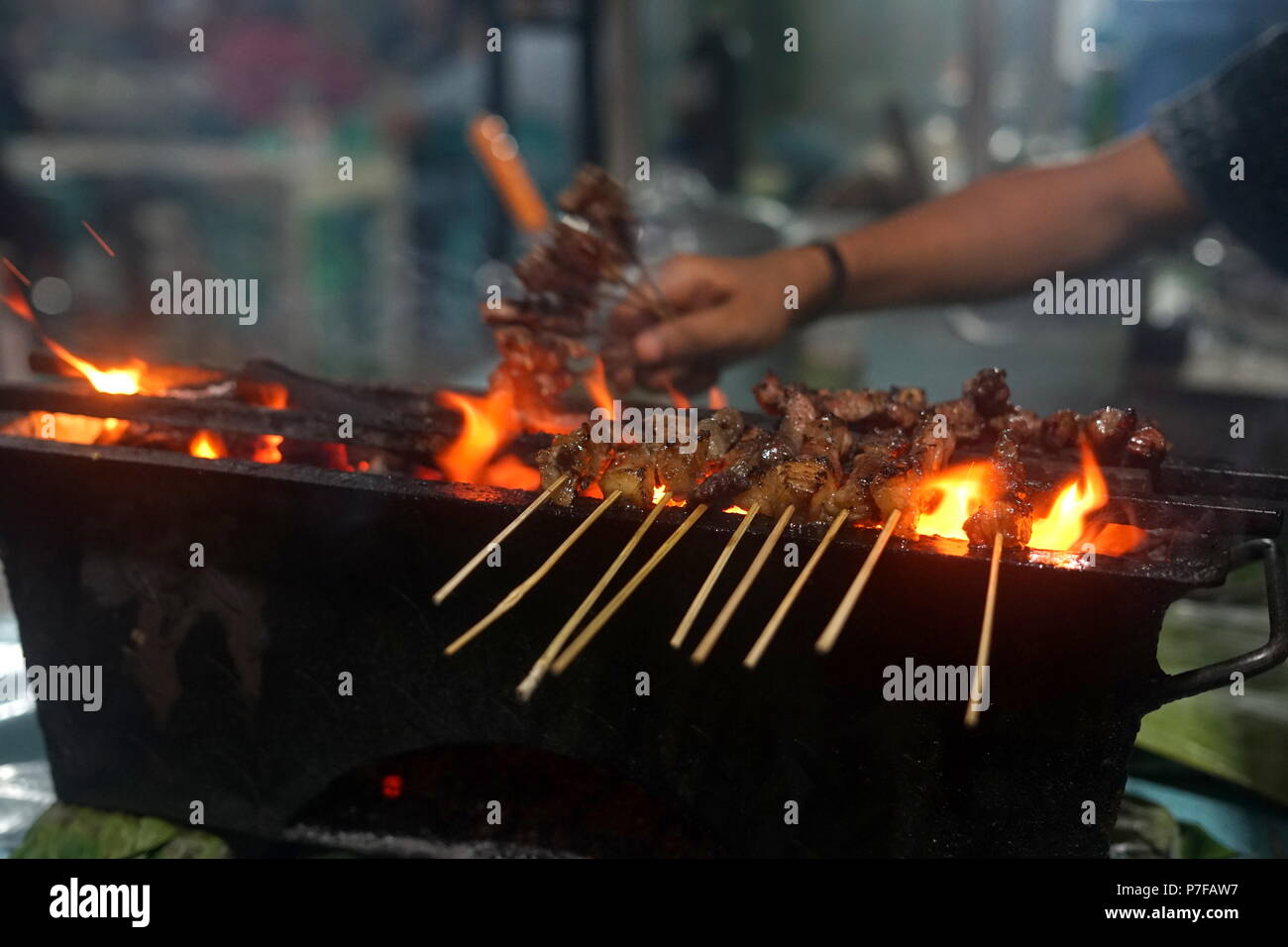 Food Vendor Grilling Meat Satay with charcoal at Street Food Market ...