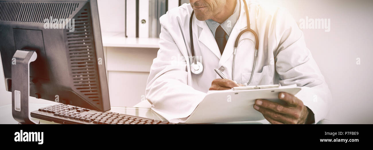 Concentrated male doctor working Stock Photo - Alamy