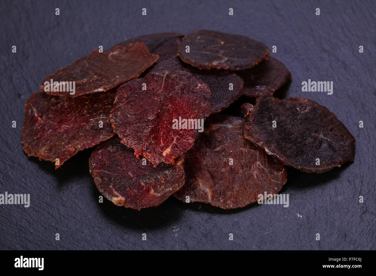 Dry beef meat over wooden Stock Photo - Alamy
