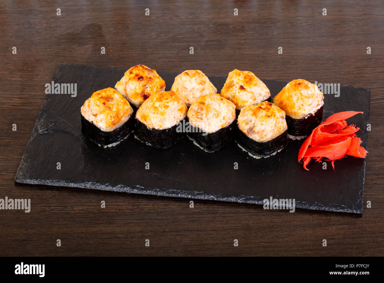 Delicious sushi roll with fried cheese Stock Photo - Alamy