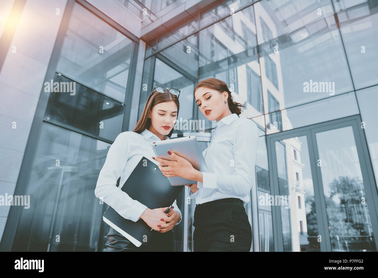 Business lady. Office staff. Two young girls with electronic tablets ...