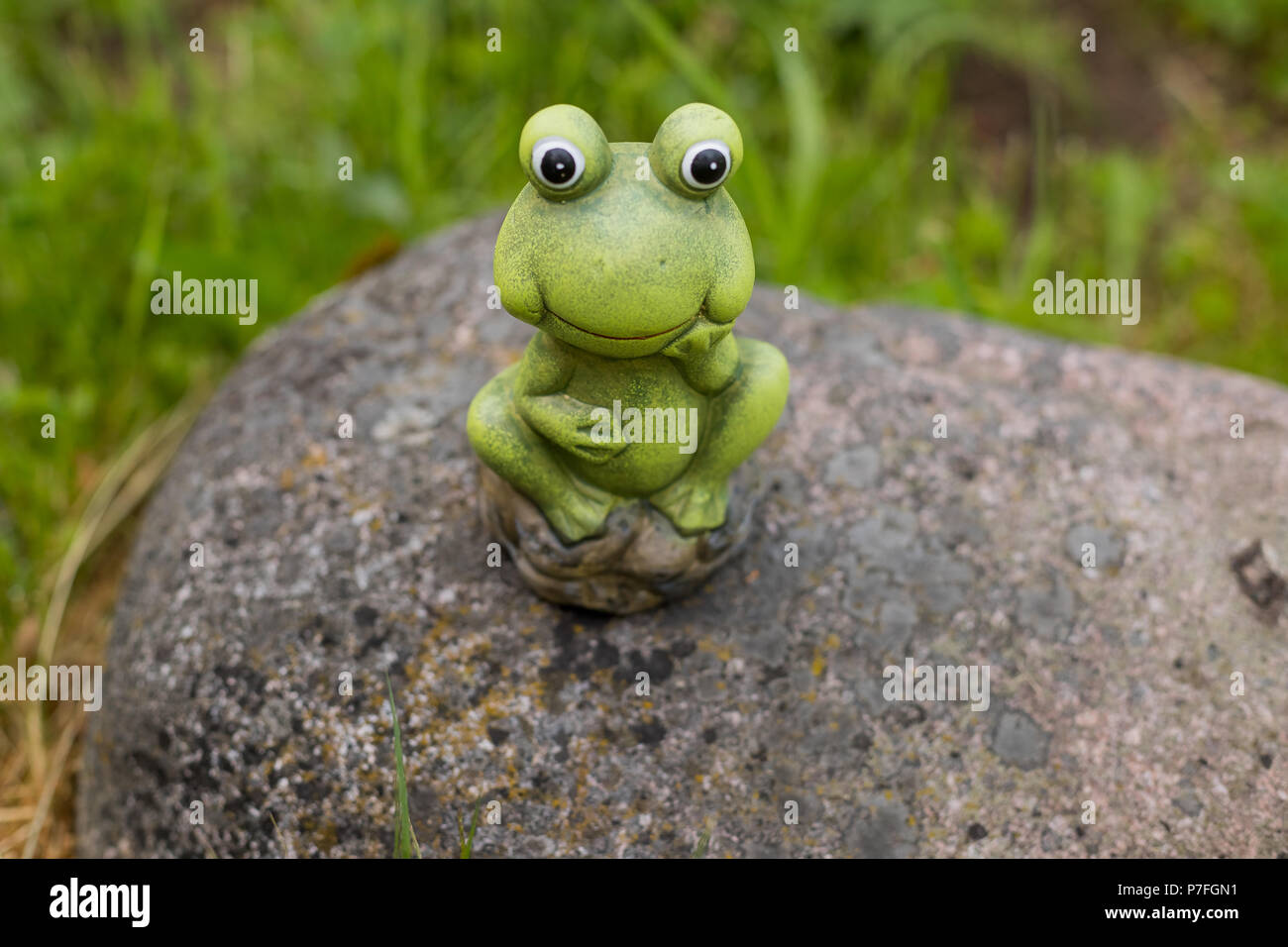 Decorative frog in the garden. ceramic green frog Stock Photo - Alamy