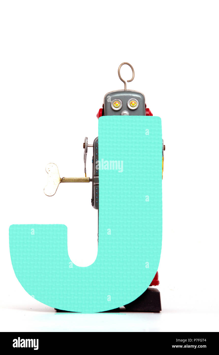 capital letter J held by vintage robot toys Stock Photo - Alamy