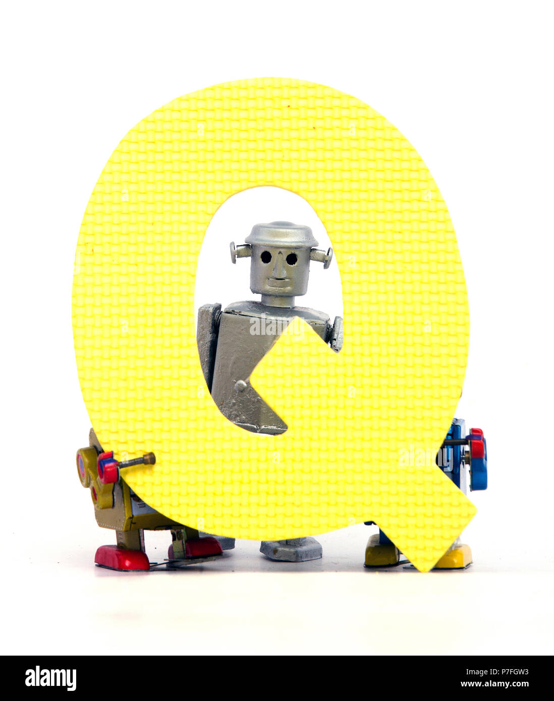 capital letter Q held by vintage robot toys Stock Photo - Alamy