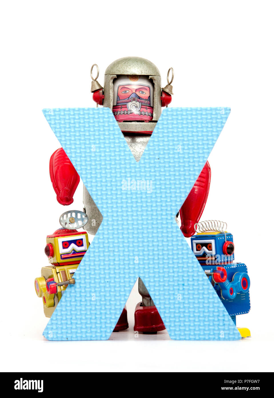 capital letter X held by vintage robot toys Stock Photo - Alamy