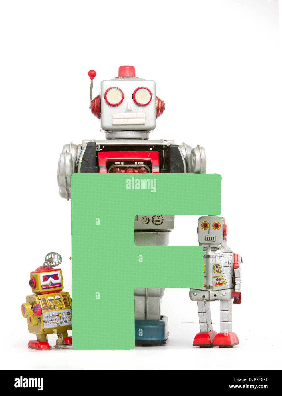 capital letter F held by vintage robot toys Stock Photo - Alamy