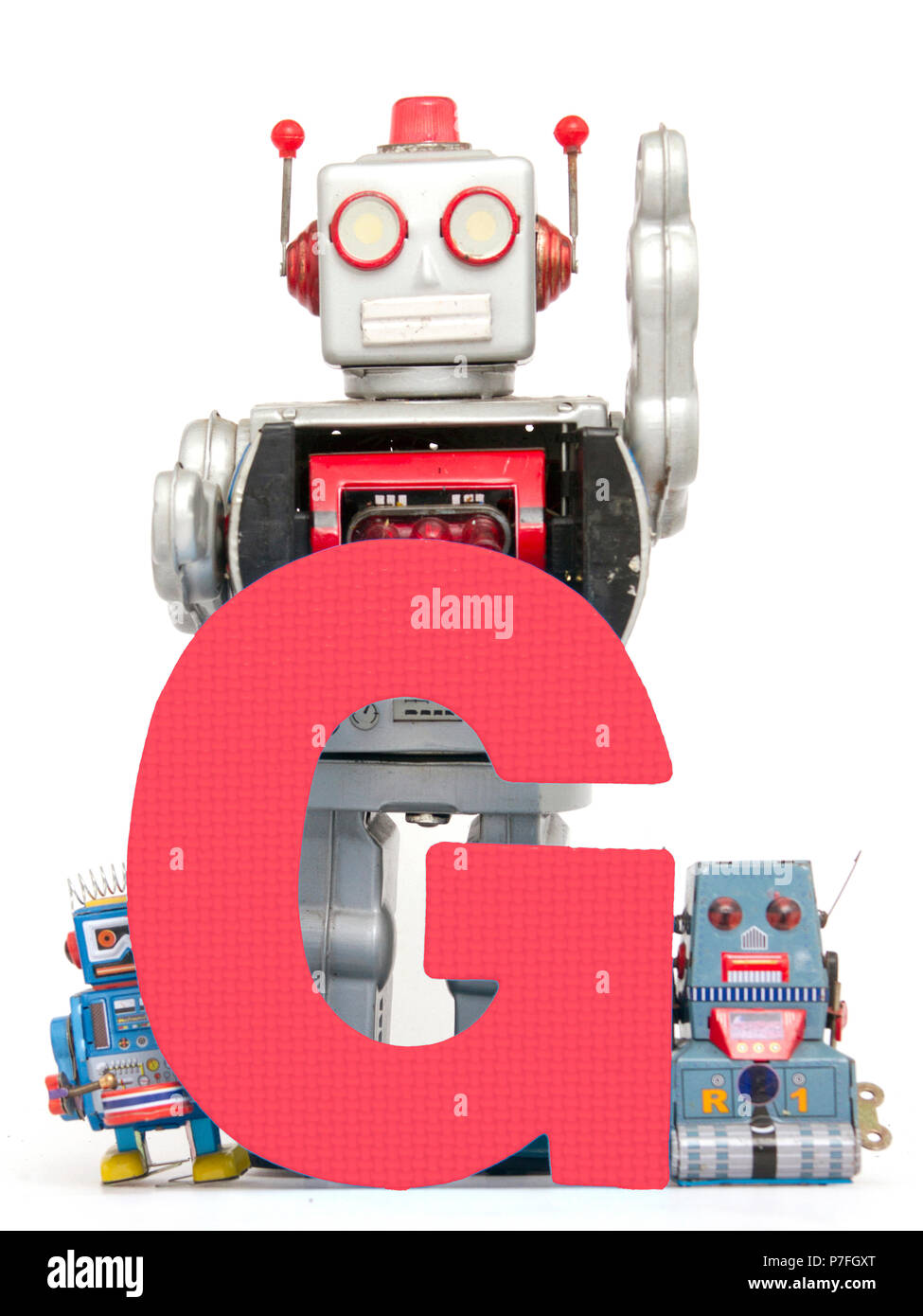 capital letter G held by vintage robot toys Stock Photo - Alamy