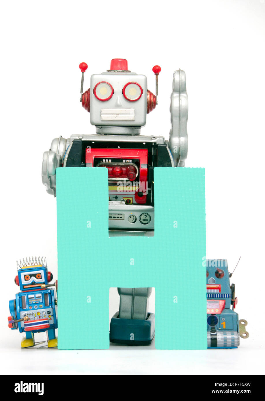 capital letter H held by vintage robot toys Stock Photo - Alamy