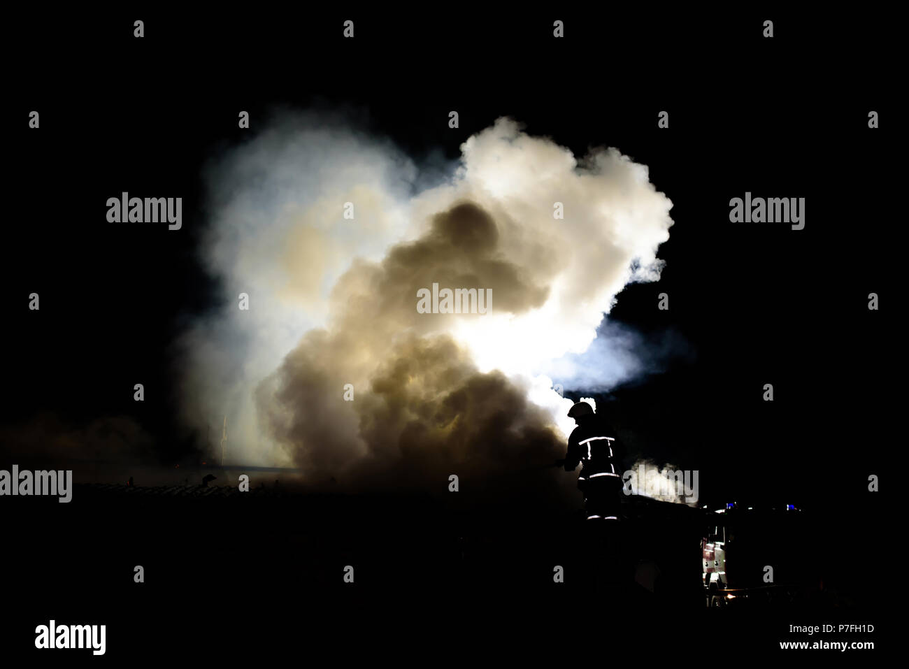 Silhouette of fireman fighting bushfire at night Stock Photo - Alamy