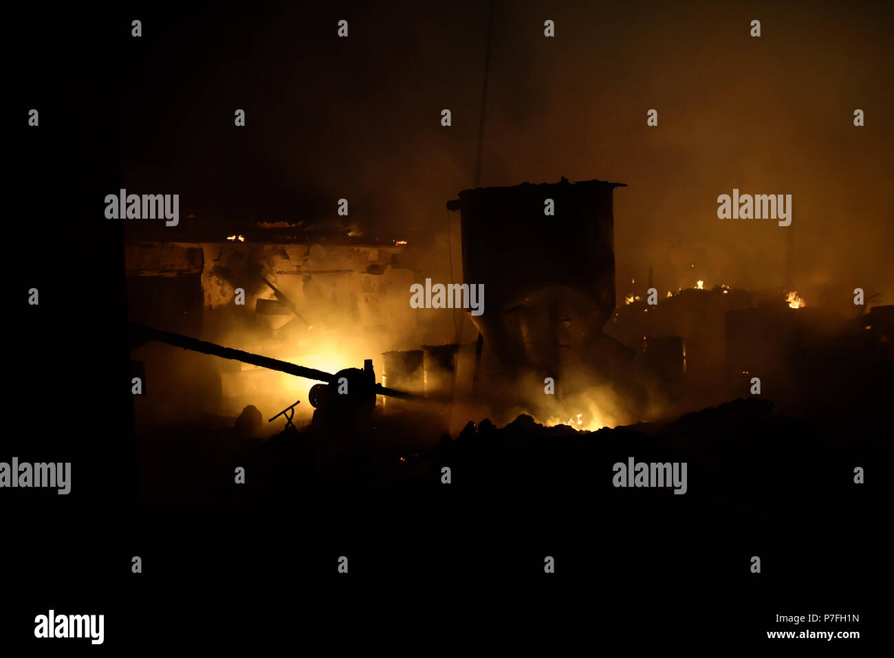 Silhouette of fireman fighting bushfire at night Stock Photo - Alamy
