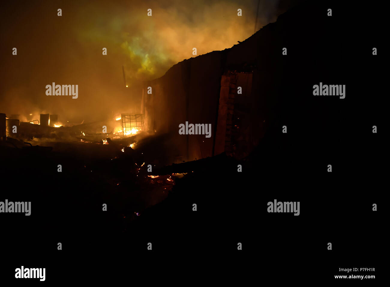 Silhouette of fireman fighting bushfire at night Stock Photo - Alamy