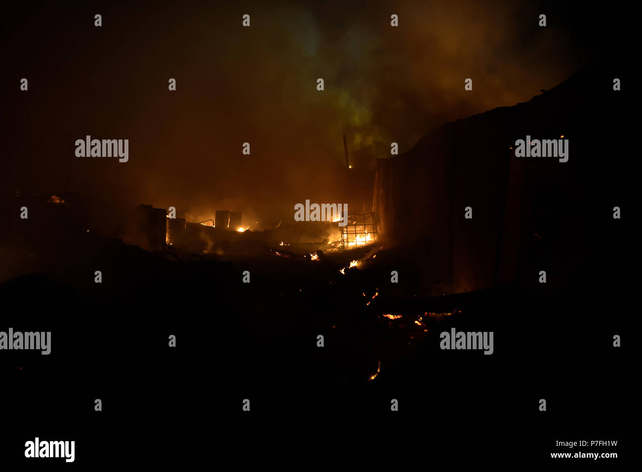Silhouette of fireman fighting bushfire at night Stock Photo - Alamy
