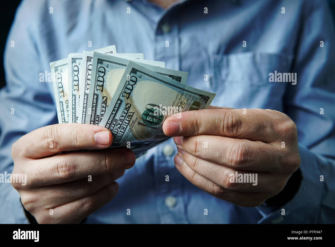 Cash in hands. Profits, savings. Stack of dollars. Man counting money ...