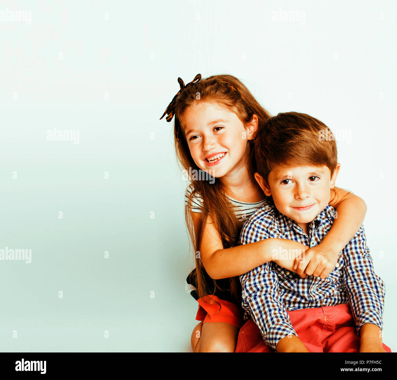 little cute boy and girl hugging playing on white background, ha Stock Photo - Alamy