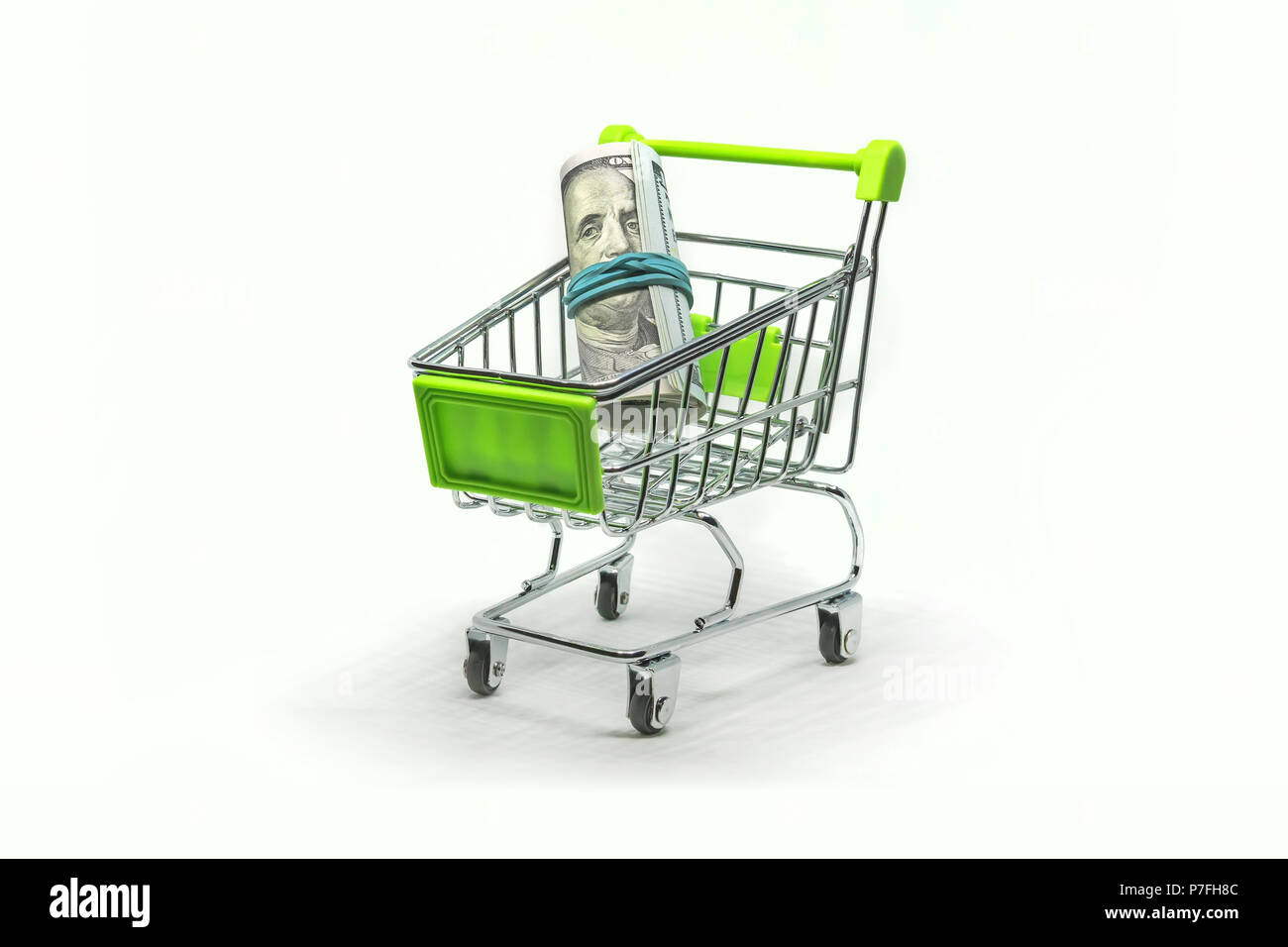 buying U.S. currency. close up dollar banknote in mini shopping cart ...