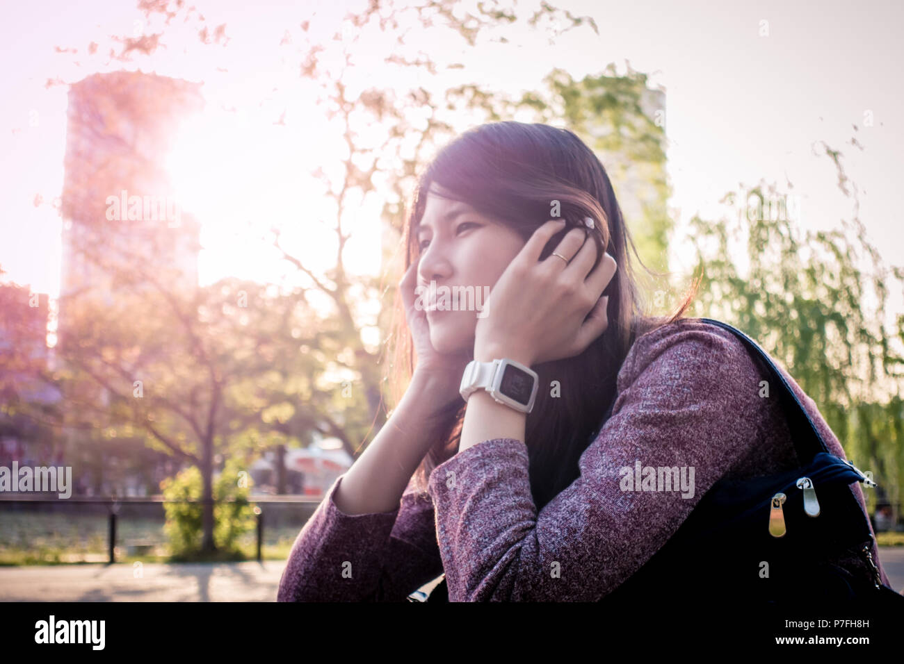 Girl sitting in park with sunlight future concept Stock Photo - Alamy