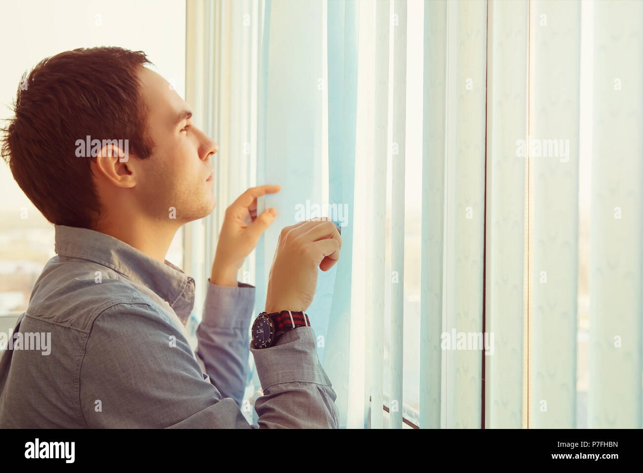 Man peeking out window hi-res stock photography and images - Alamy