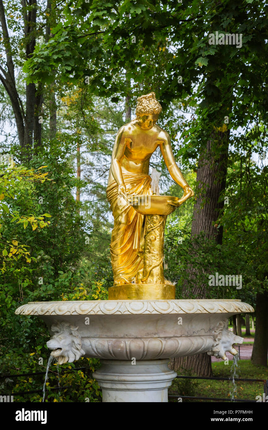 Close-up of marble water fountain with golden goddess statue, Peterhof ...