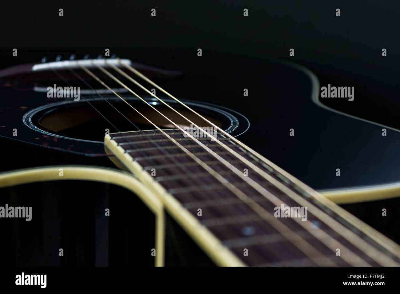 acoustic guitar on dark backdrop Stock Photo - Alamy