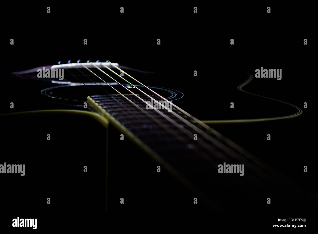 acoustic guitar on dark backdrop Stock Photo - Alamy