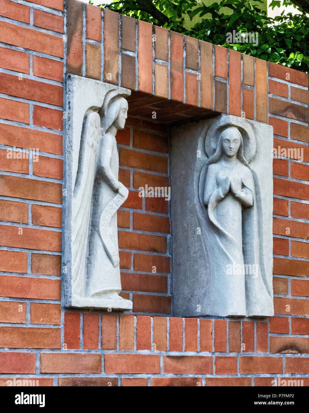 Berlin-Dahlem..Sculpture of two angels in wall alcove in garden of St ...