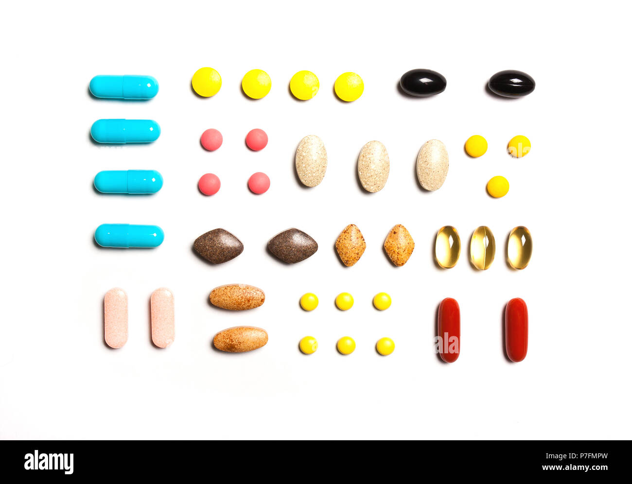 Vitamins, dietary supplements in a row on a white background ...
