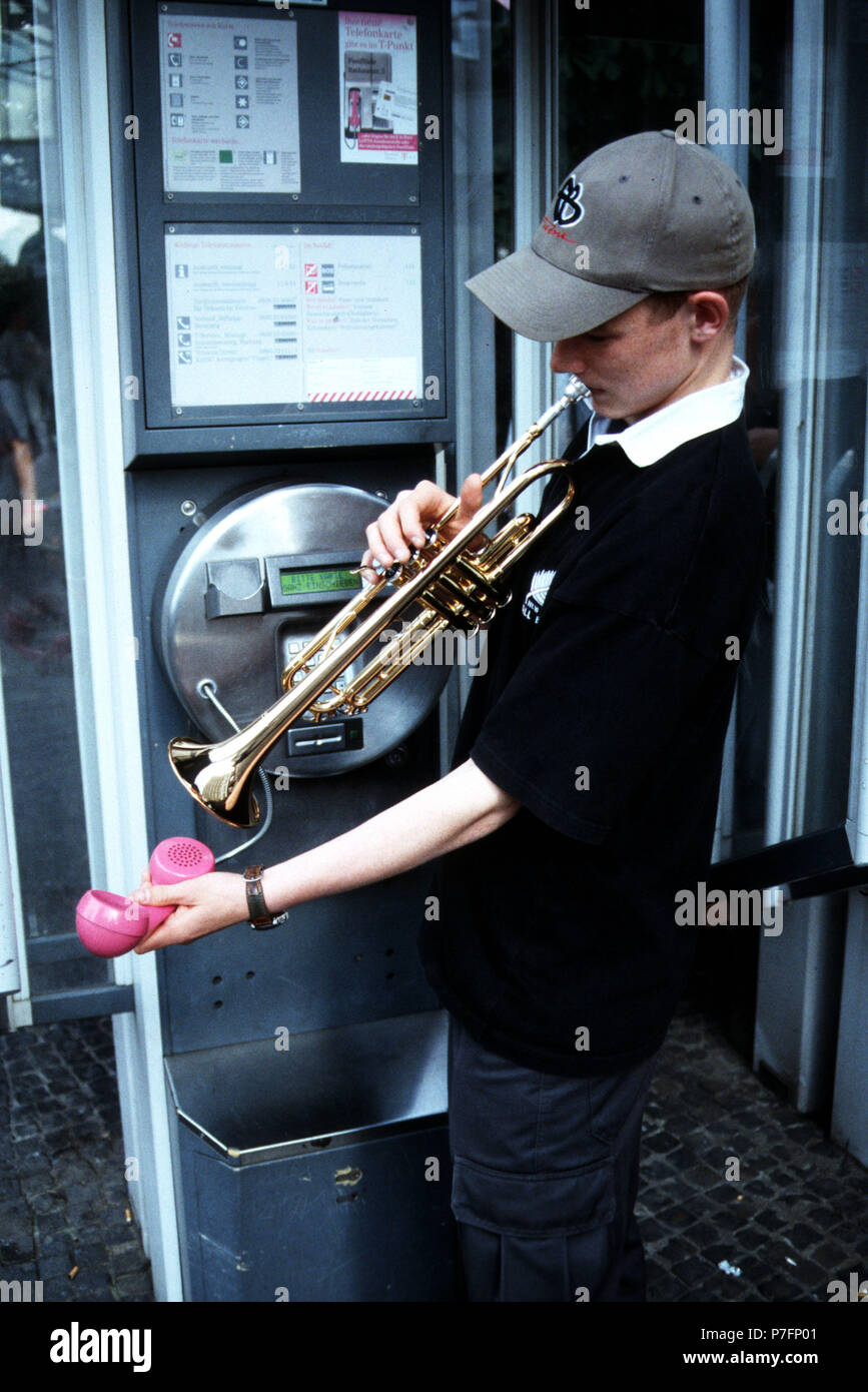 Trumpet player in the telephone booth, Berlin, Germany Stock Photo - Alamy
