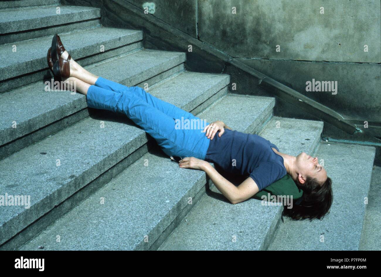 Woman sleeping with head down on stairs, Berlin, Germany Stock Photo ...